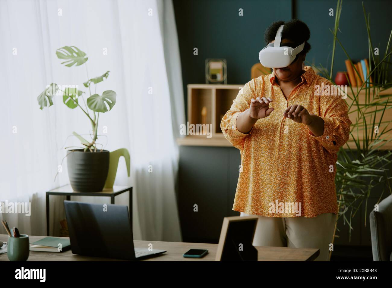 Woman exploring internet using virtual hi-res stock photography and ...