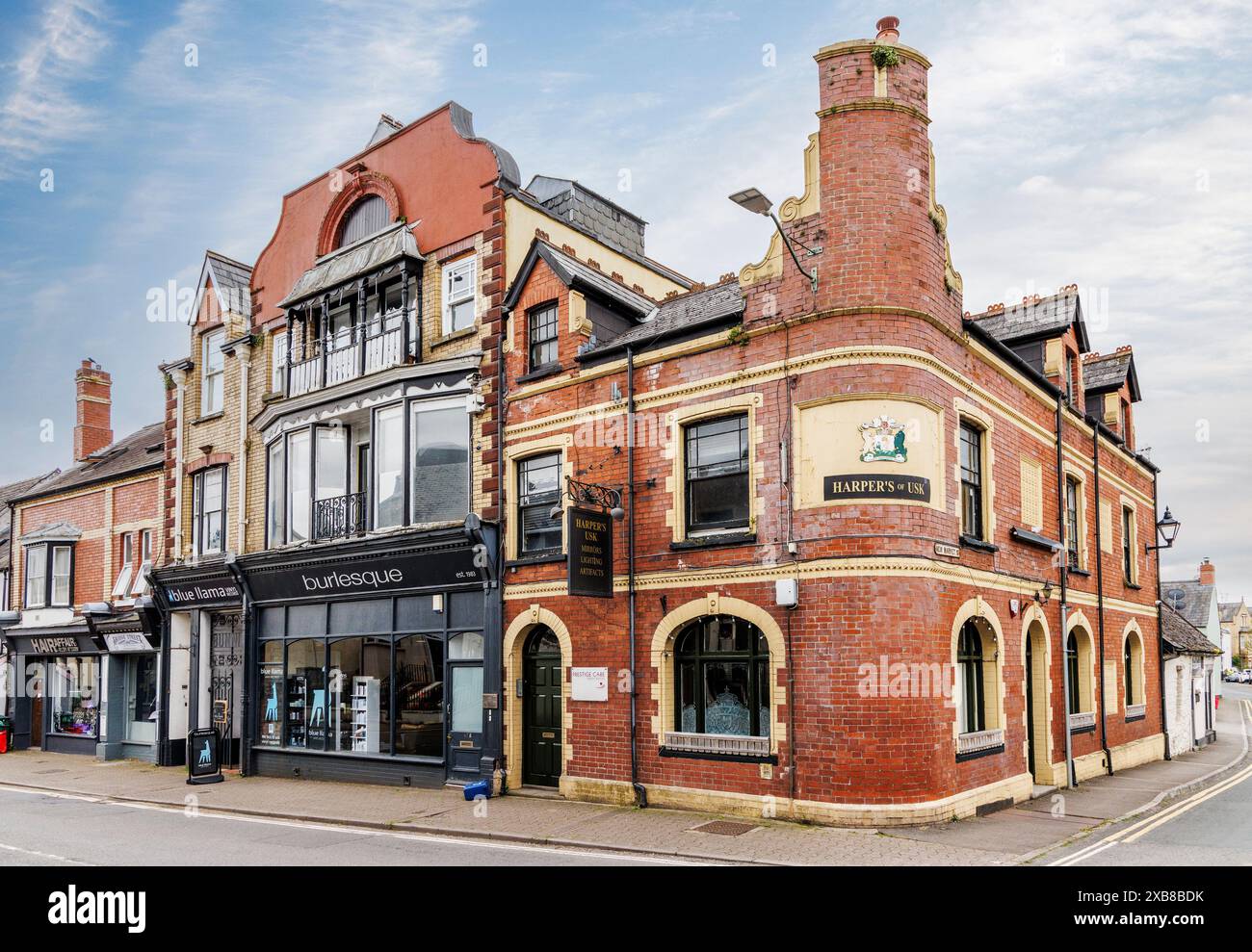 Old red brick building, |Harpers of Usk with town crest, Usk ...
