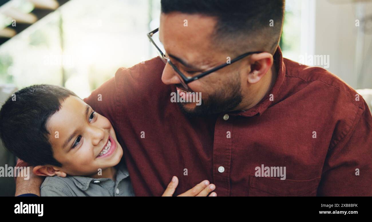Smile, hug and child with dad on sofa in home relaxing together for ...