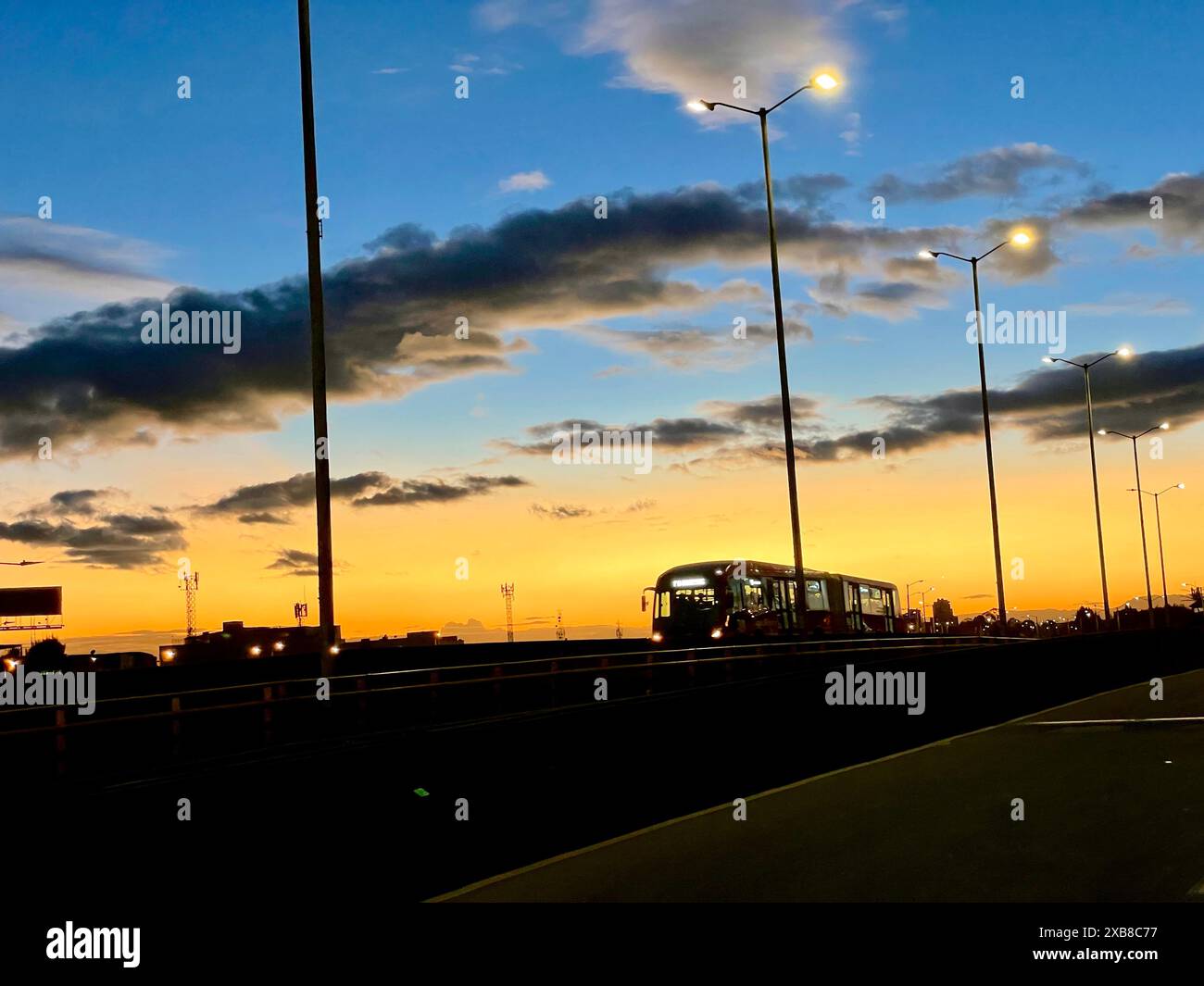 Busy highway with heavy traffic next to tall poles Stock Photo - Alamy