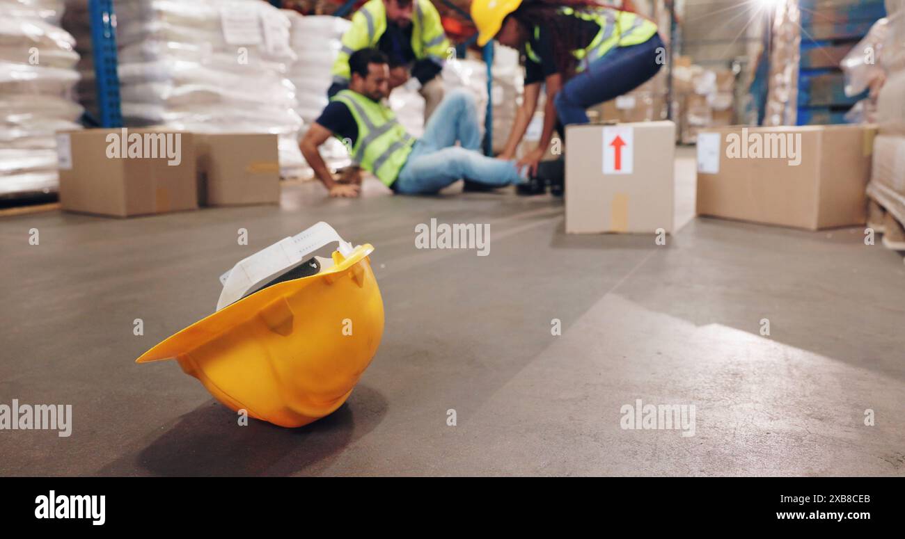 Accident, fall and hardhat with man in warehouse for delivery ...