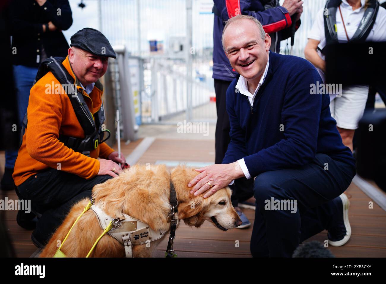 Liberal Democrats leader Sir Ed Davey pets a working Guide Dog during a ...