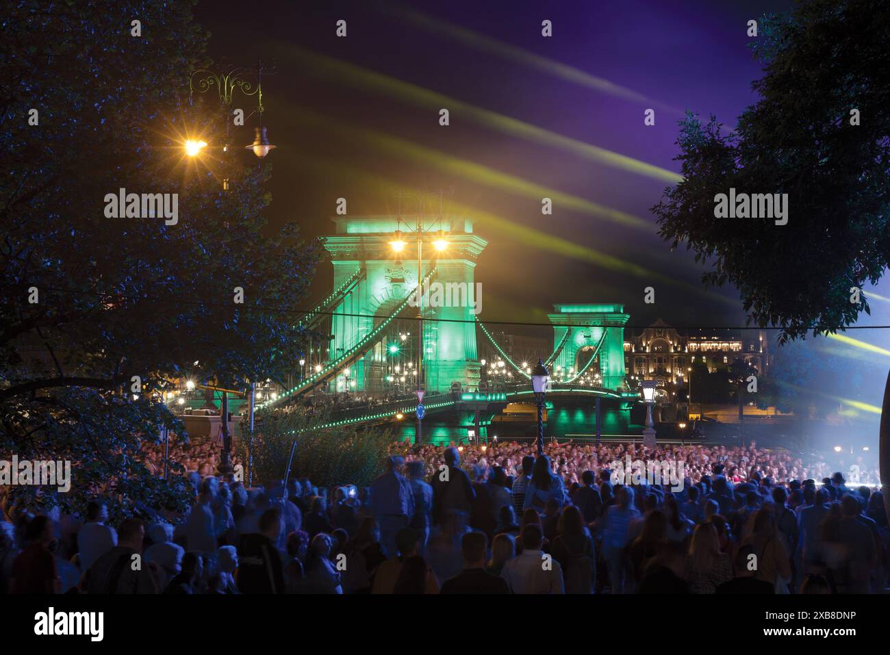 Night event against Chain Bridge, crowd of people Stock Photo - Alamy