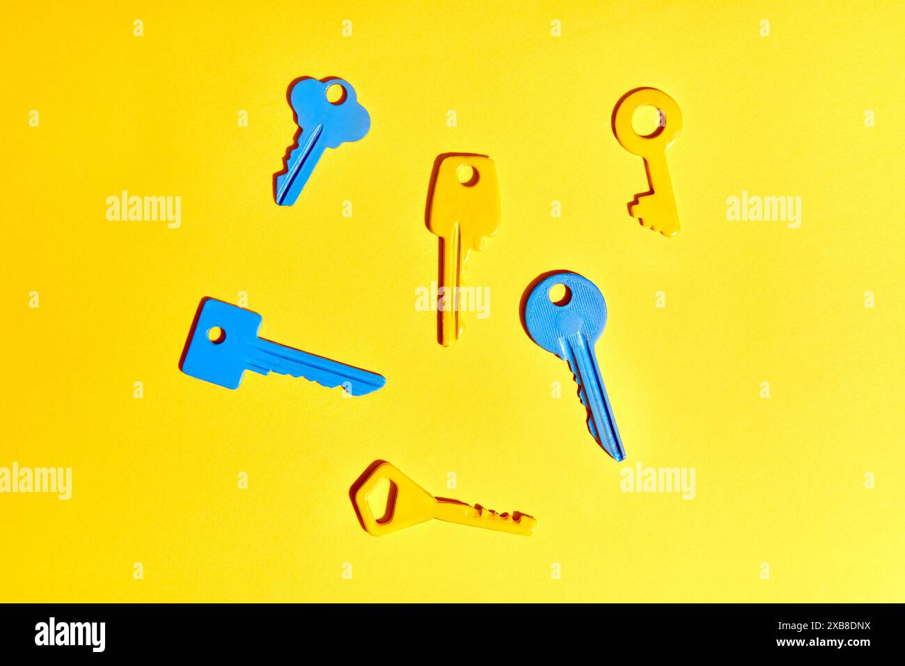 Colorful keys on yellow background. Flat lay Stock Photo - Alamy