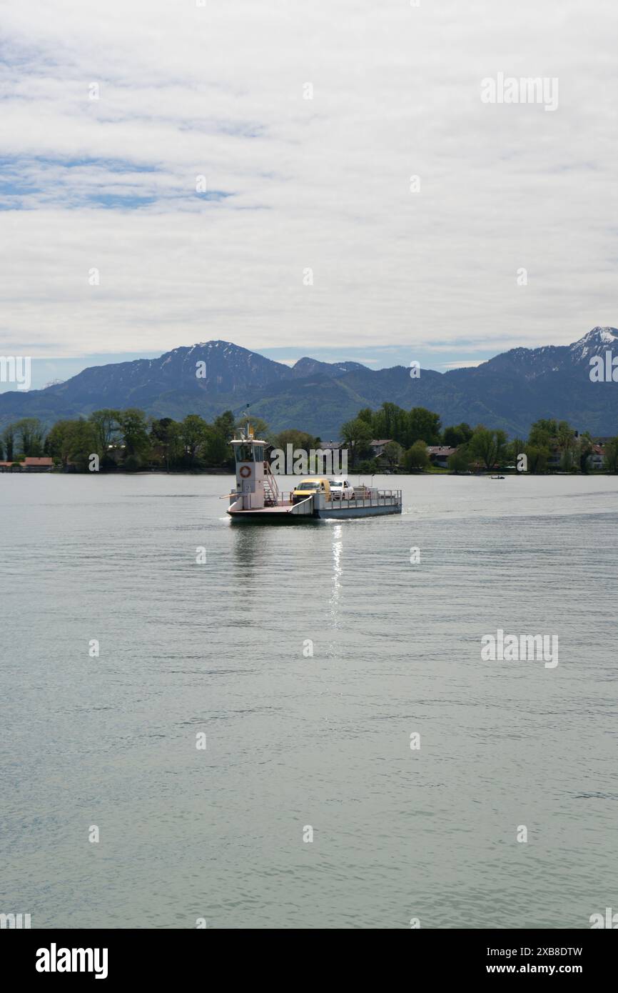 Large boat floating across a large body of water with mountains in the ...