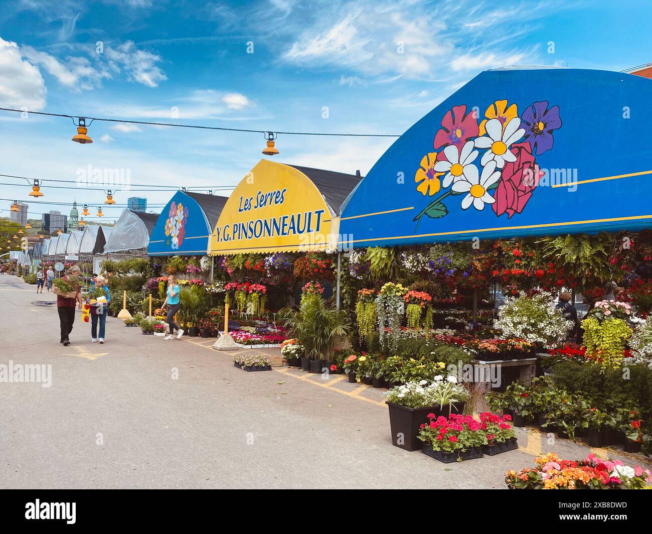 A flower shop in a town on a roadside with pedestrians passing by Stock ...