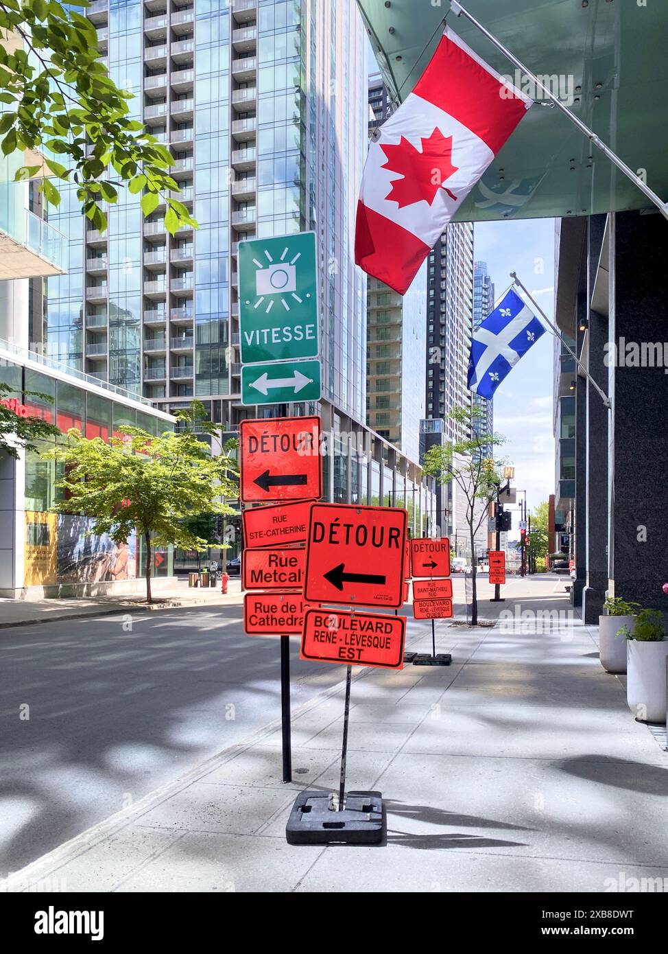 Canadian flag and various signs on a sidewalk Stock Photo - Alamy