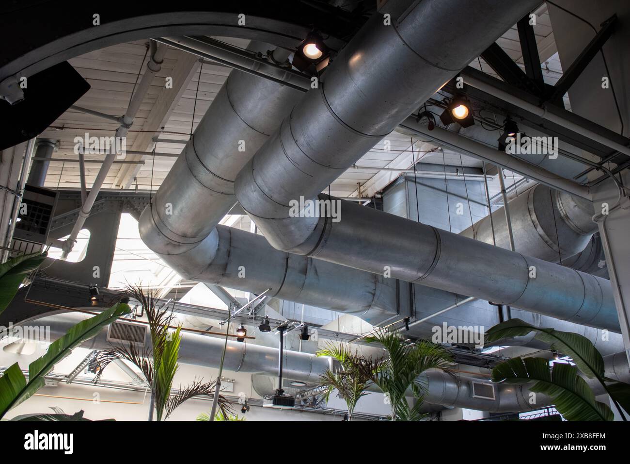 A low-angle shot of pipes and wires in a building, industrial ...
