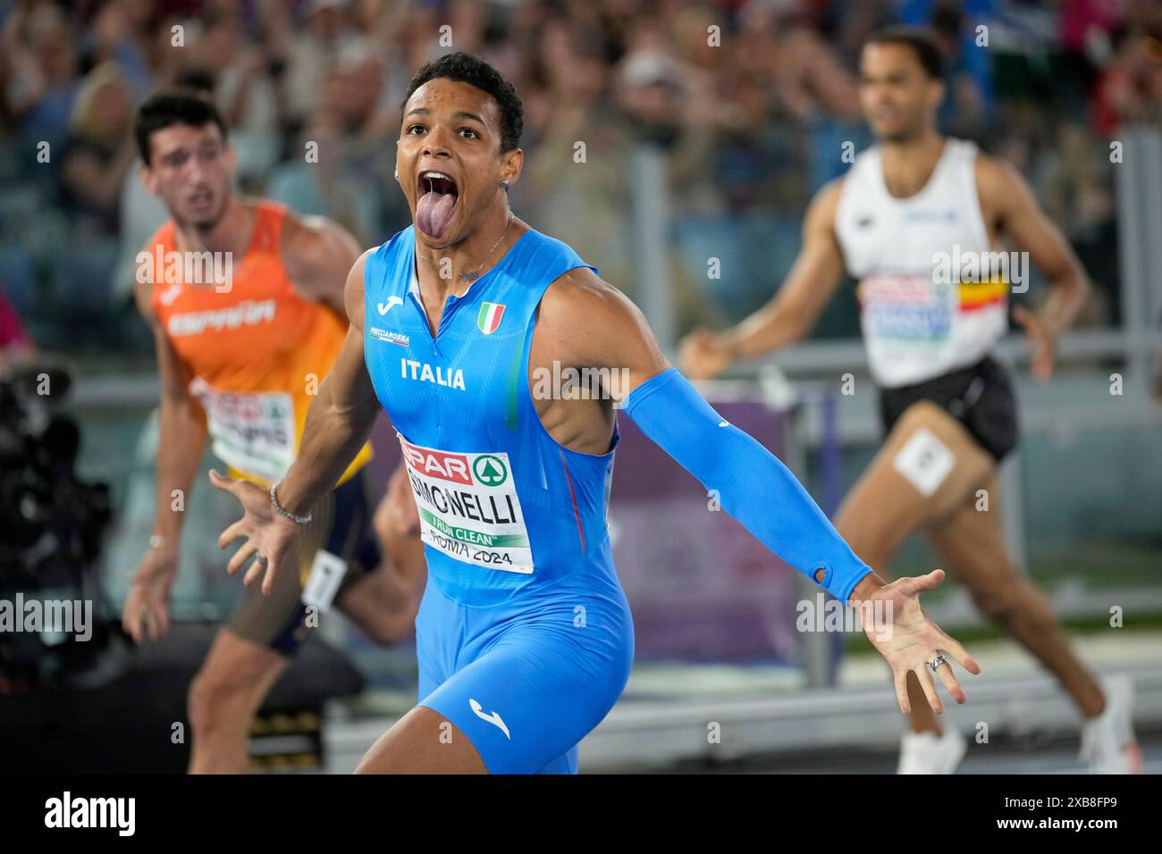 Lorenzo Simonelli, of Italy, celebrates as he crosses the finish line ...