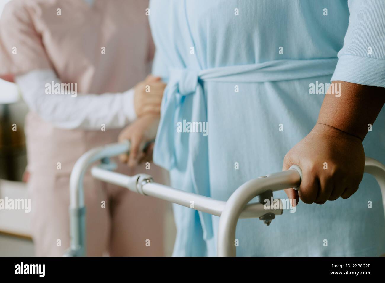 Mature African American female patient making special effort to walk ...