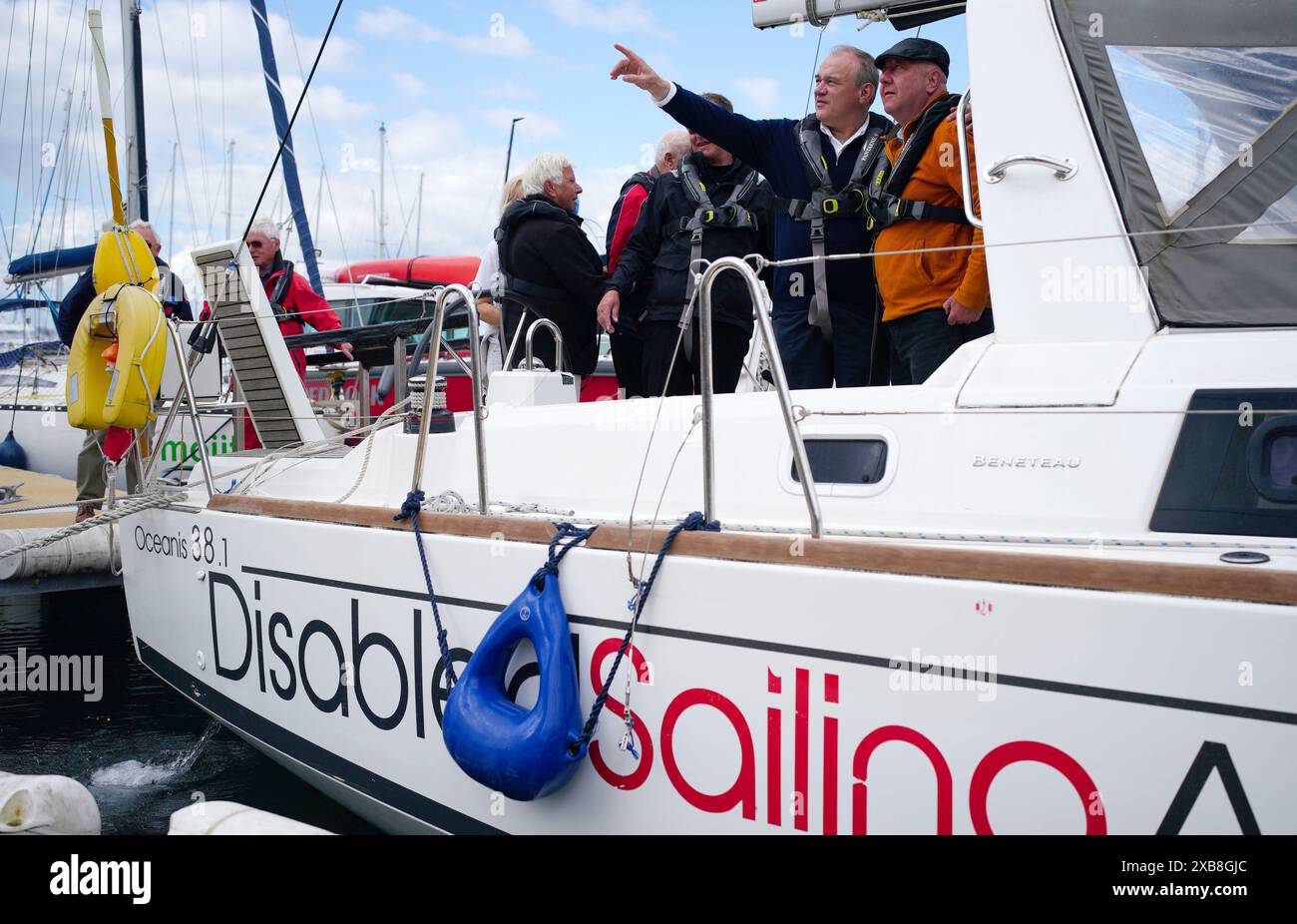 Liberal Democrats leader Sir Ed Davey (second right) on board the ...