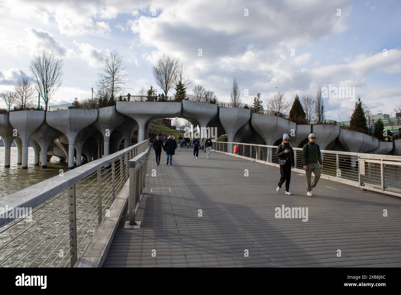 The pedestrians crossing the bridge with the view of Little Island Park ...