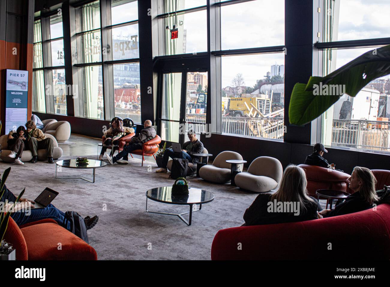 A diverse group sitting on chairs and working. Google Pier 57, New York ...