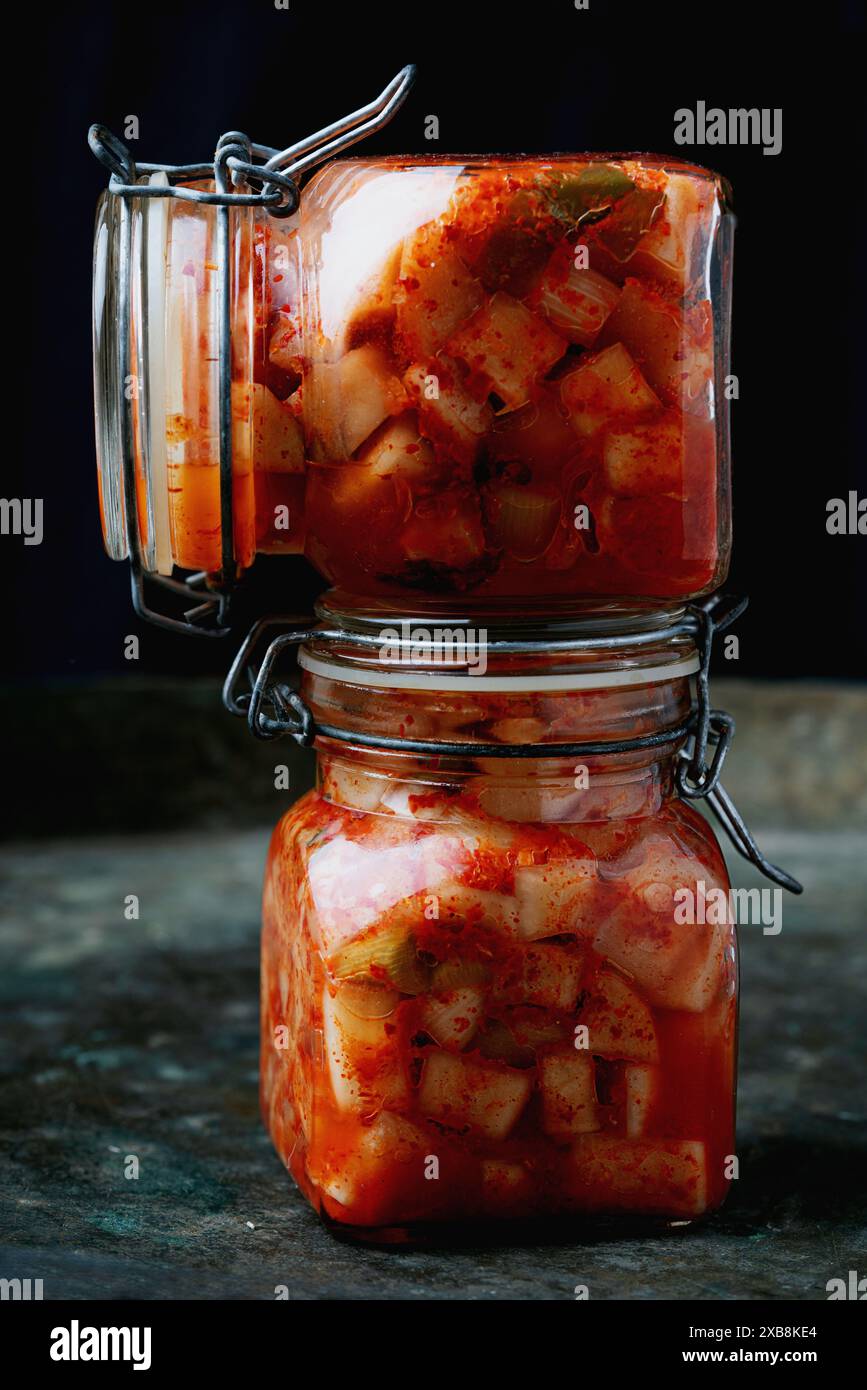 Glass jar filled with traditional Korean radish kimchi Kkakdugi, a ...