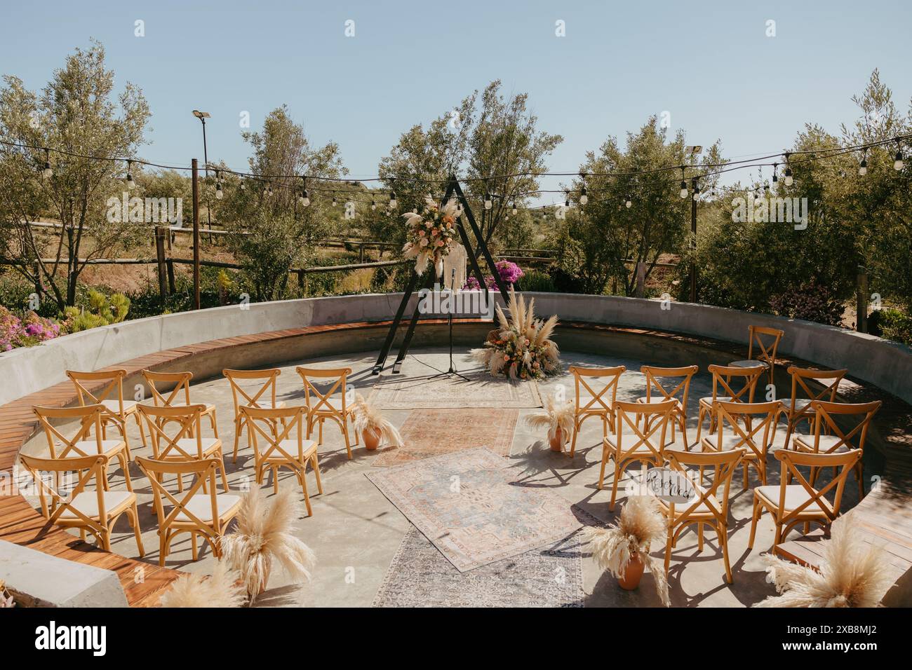 Outdoor wedding ceremony with ring-shaped seating and decorations Stock ...