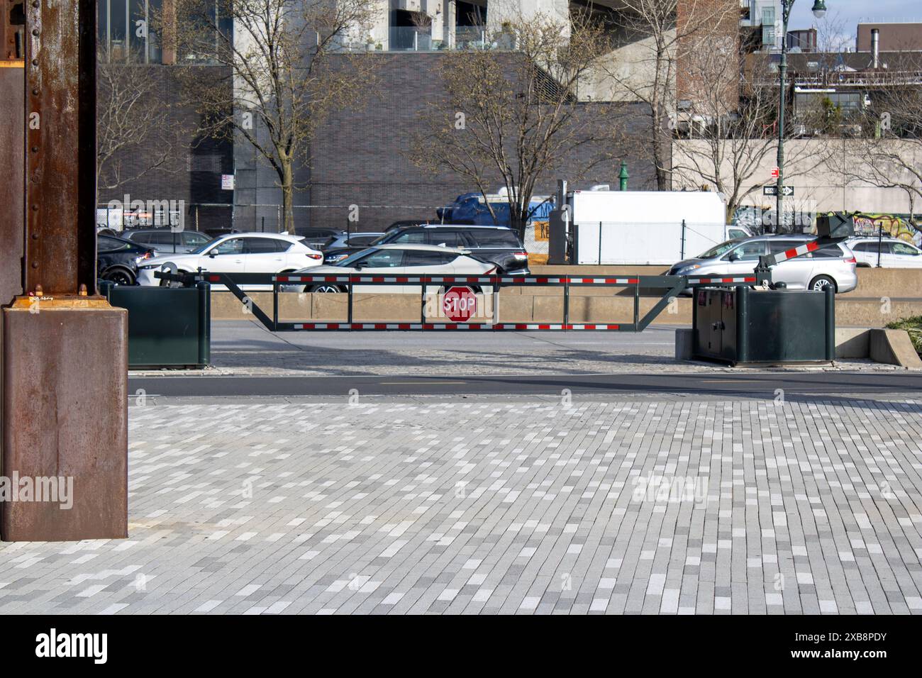 The cars parked behind barriers with guard gates on the street Stock ...