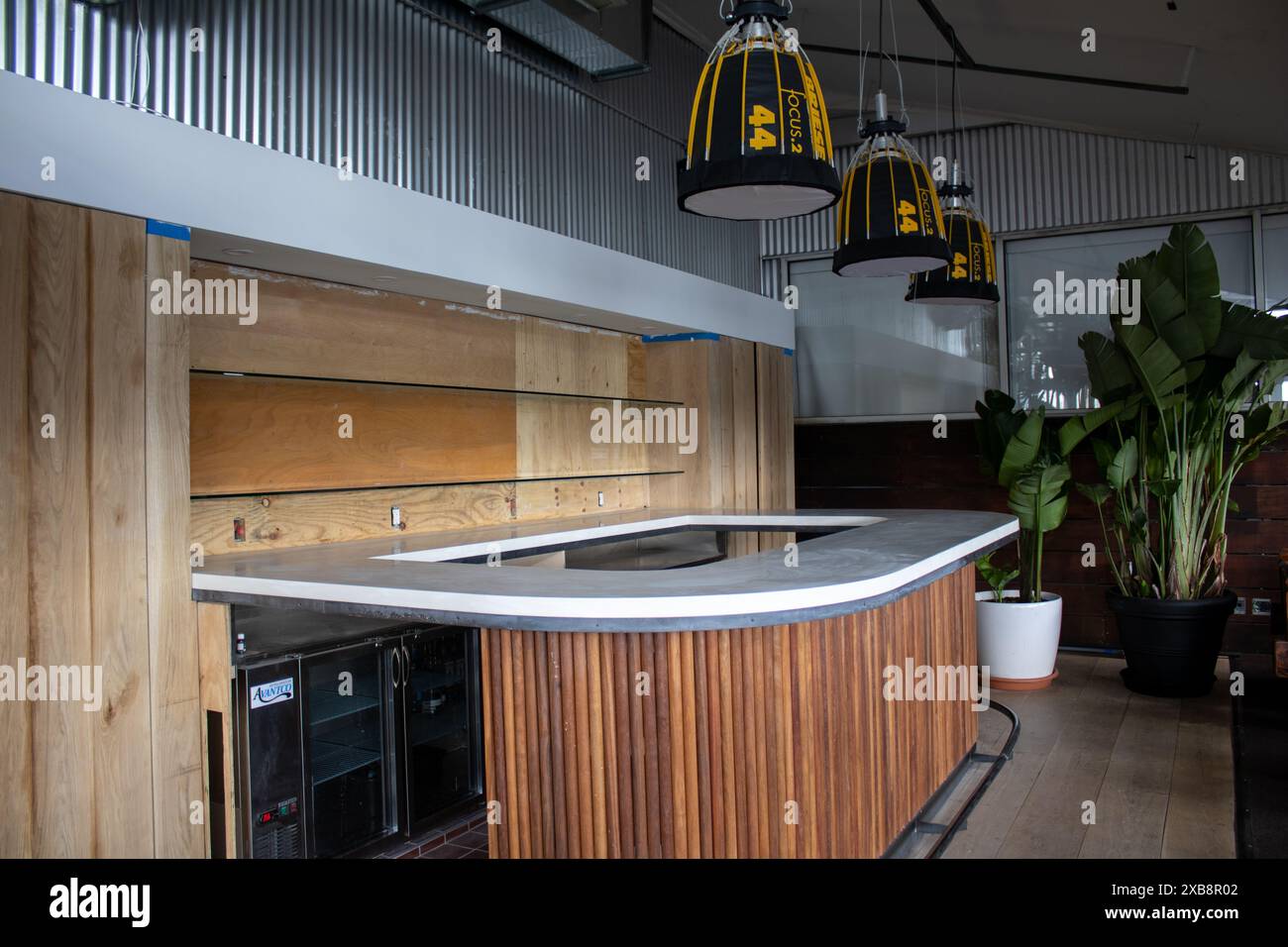 A Kitchen counter with three sleek black pendant lights in a modern ...