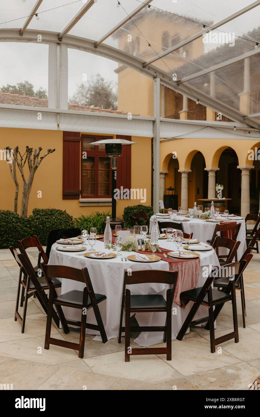 A beautiful intimate wedding reception in a spacious courtyard under a ...