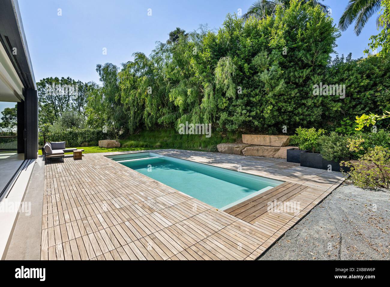 Backyard pool with adjacent lounge area Stock Photo - Alamy