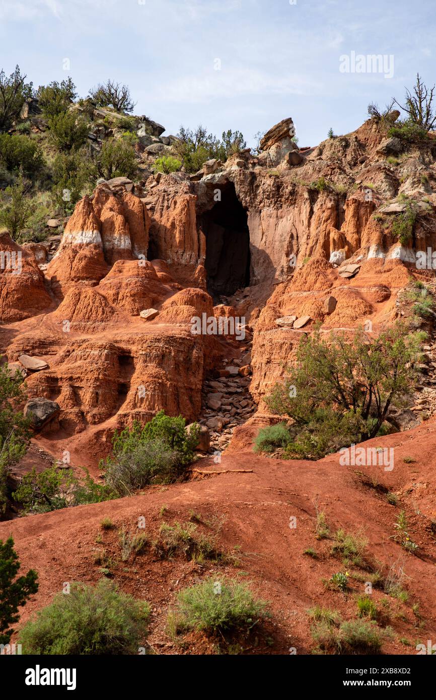 A narrow mountain path with a tree-filled hole in the foreground Stock ...