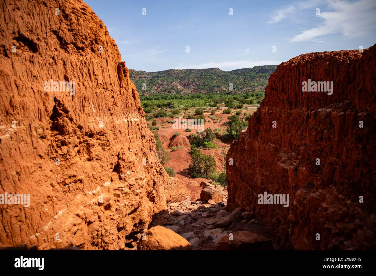 Scenic view from rocky elevation overlooking hills and shrubs below ...
