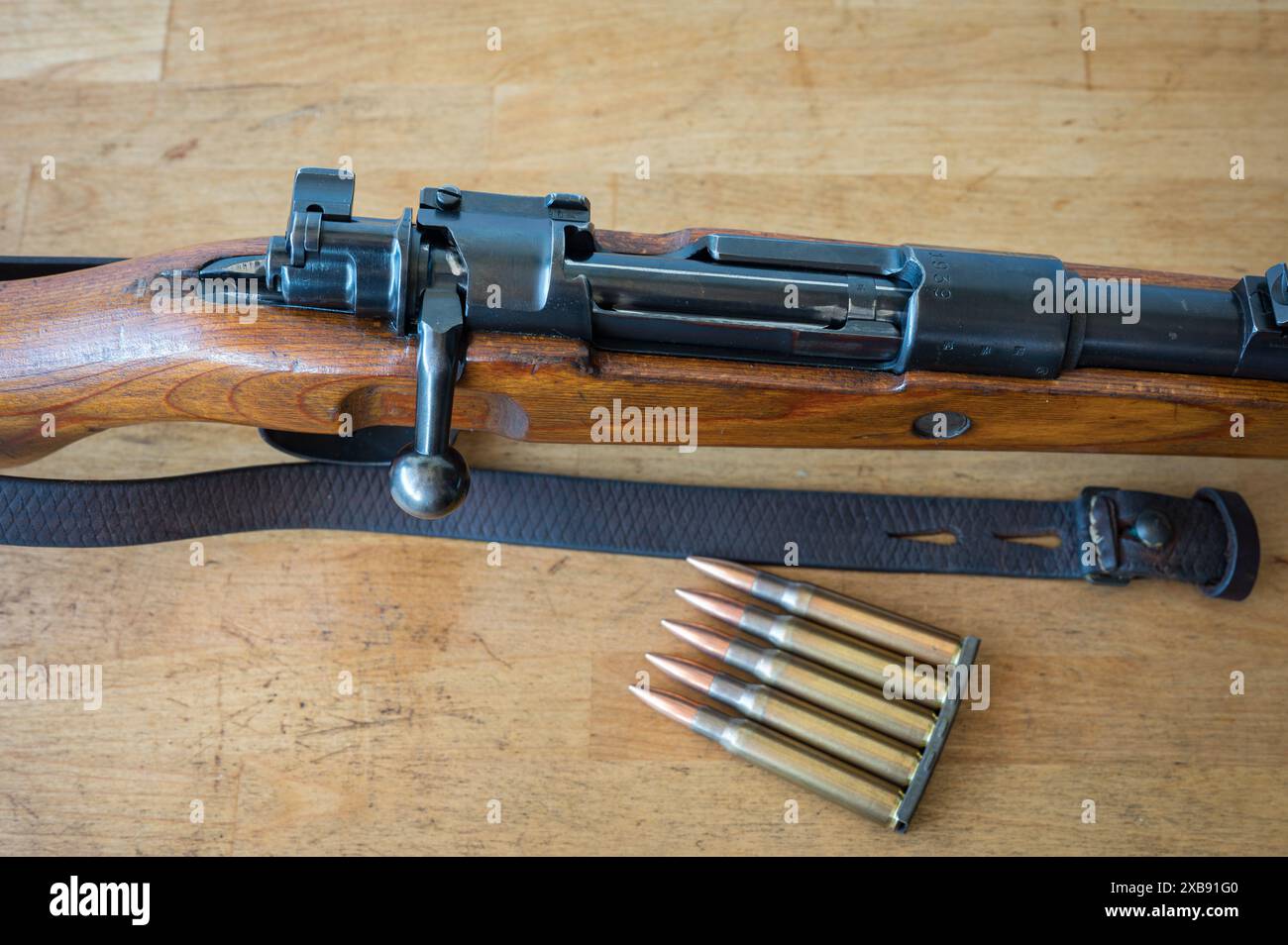 Detail of an ammunition clip with 5 30-06 caliber rifle bullets next to ...