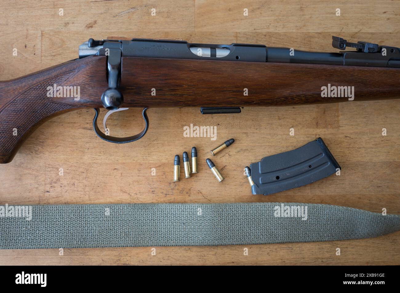 Detail of an old standard .22 caliber bolt action carbine on a wooden ...