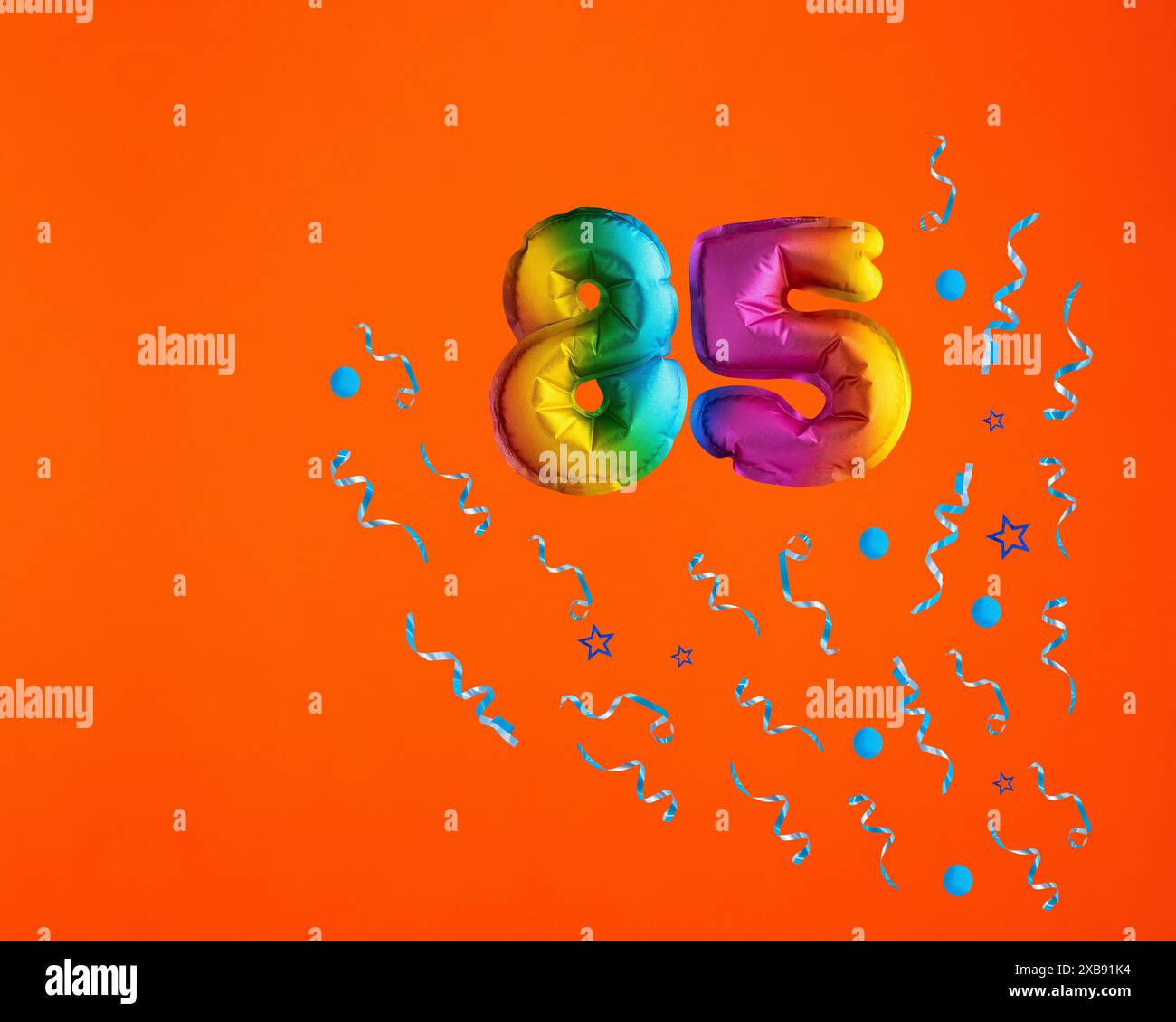Confetti explosion with number 85 balloon - Celebration on orange ...