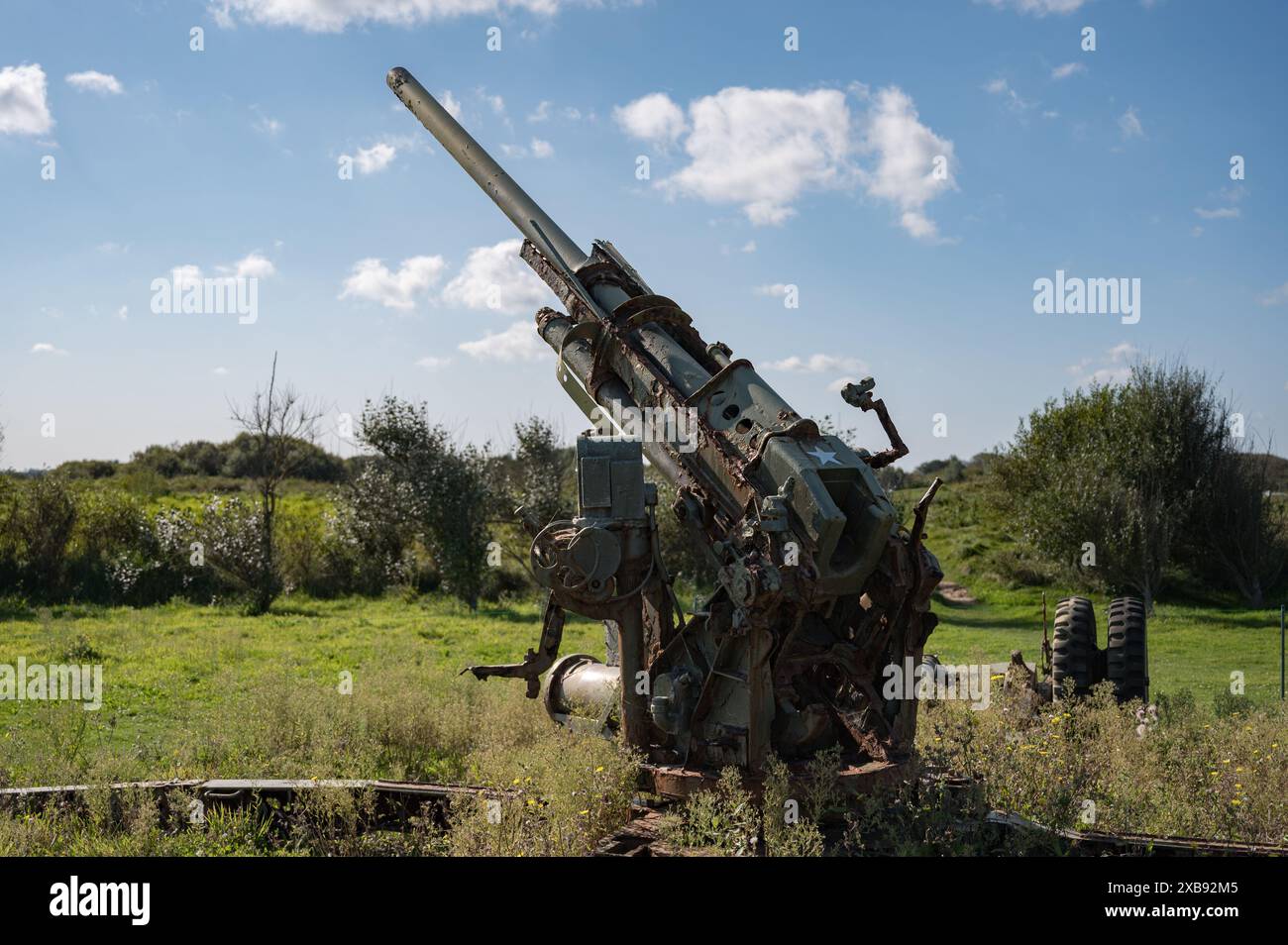An old anti-aircraft gun from the Second World War, in a field in ...