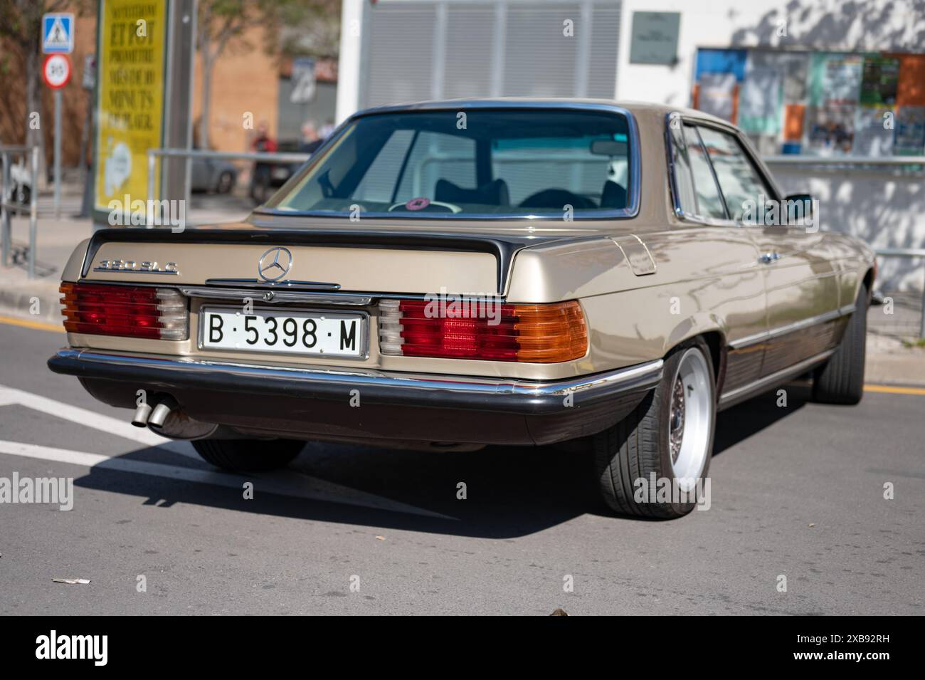 A rear view of a classic gold Mercedes Benz SLC 350 C107 Coupe parked ...
