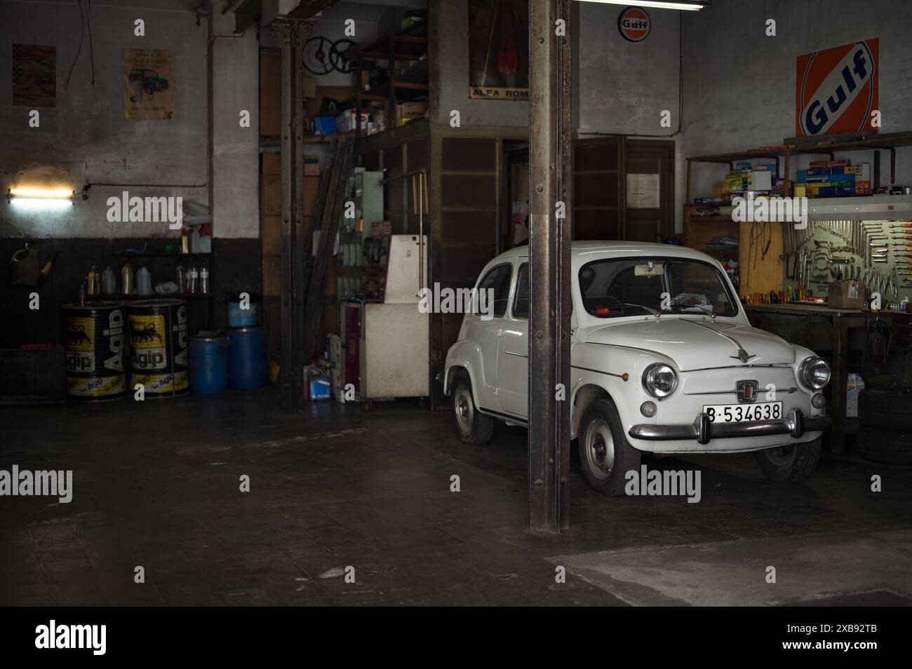 An old car mechanic workshop with a white Seat 600 inside Stock Photo ...