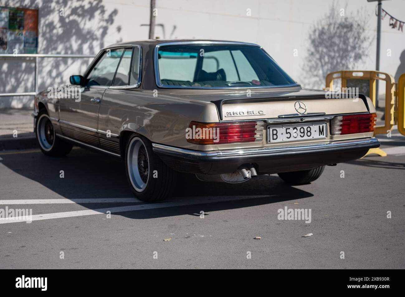 A rear view of a classic gold Mercedes Benz SLC 350 C107 Coupe parked ...