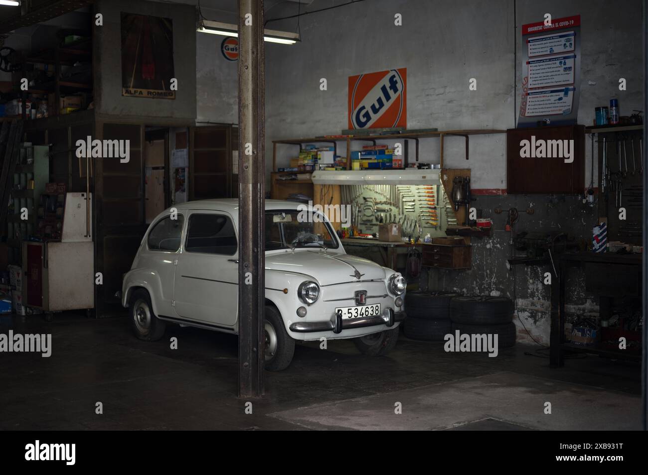An old car mechanic workshop with a white Seat 600 inside Stock Photo ...