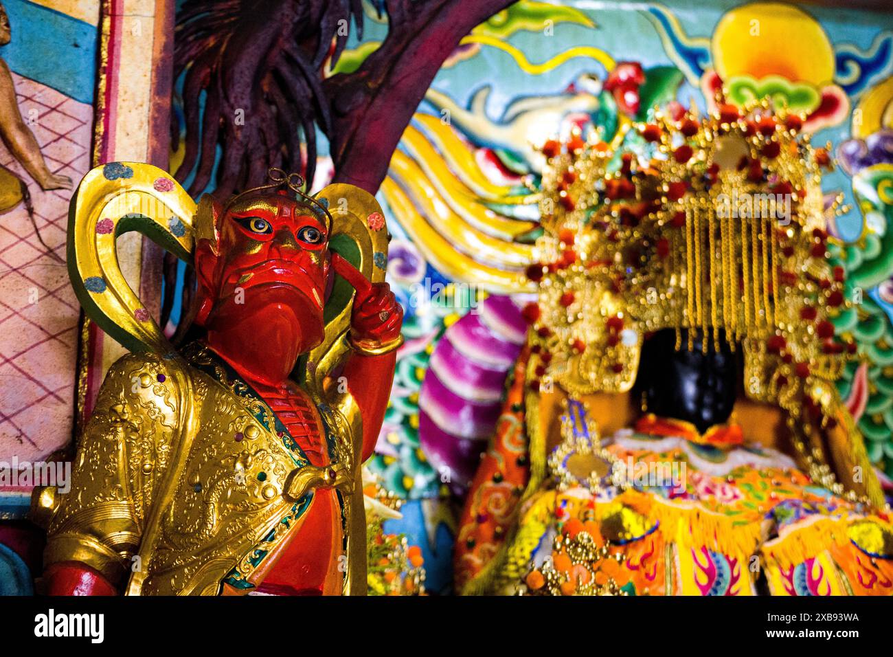 A red Statue of a creature and a decor on display in a religious ...