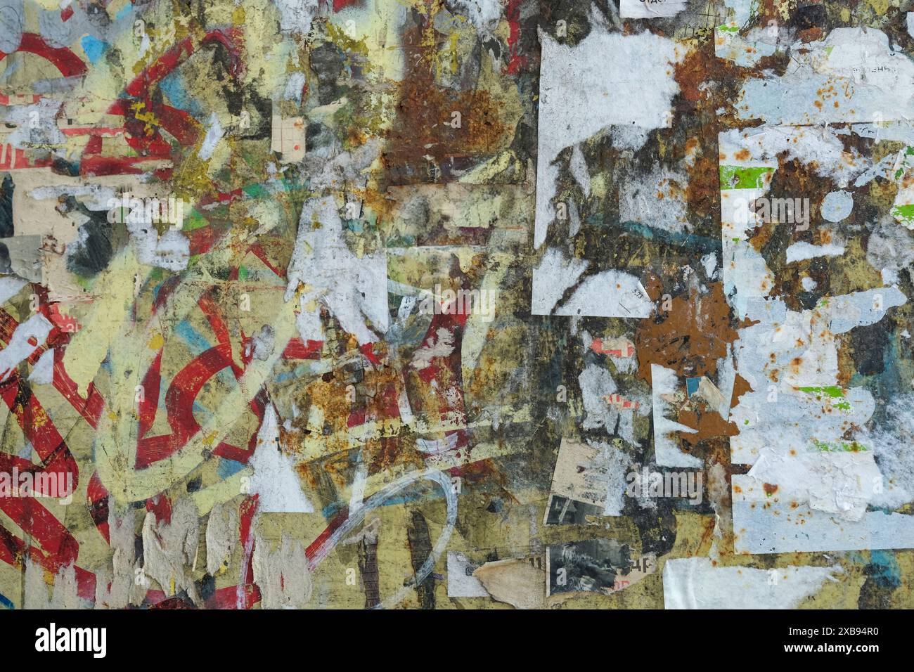 Close-up of an urban bulletin board with torn paper announcements and ...