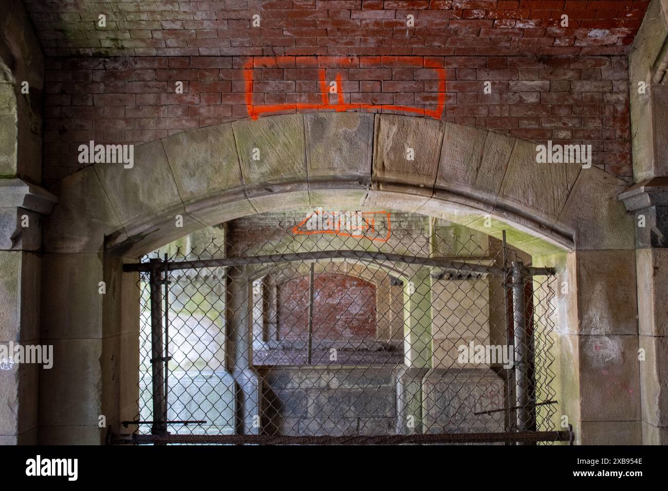 A graffiti-covered prison entrance built with bricks Stock Photo - Alamy