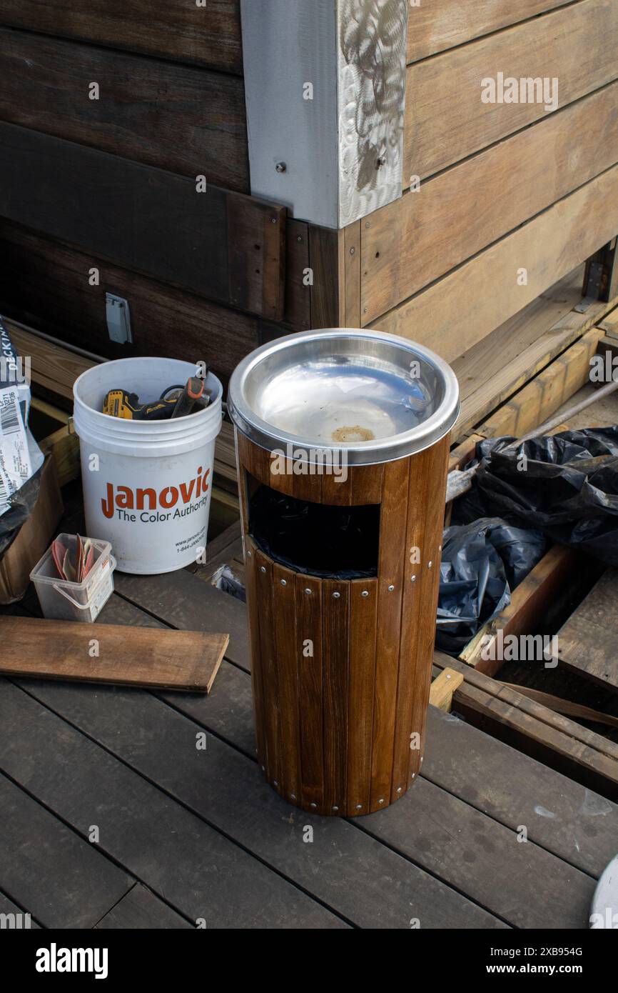 A trash can placed near the house's buckets Stock Photo - Alamy
