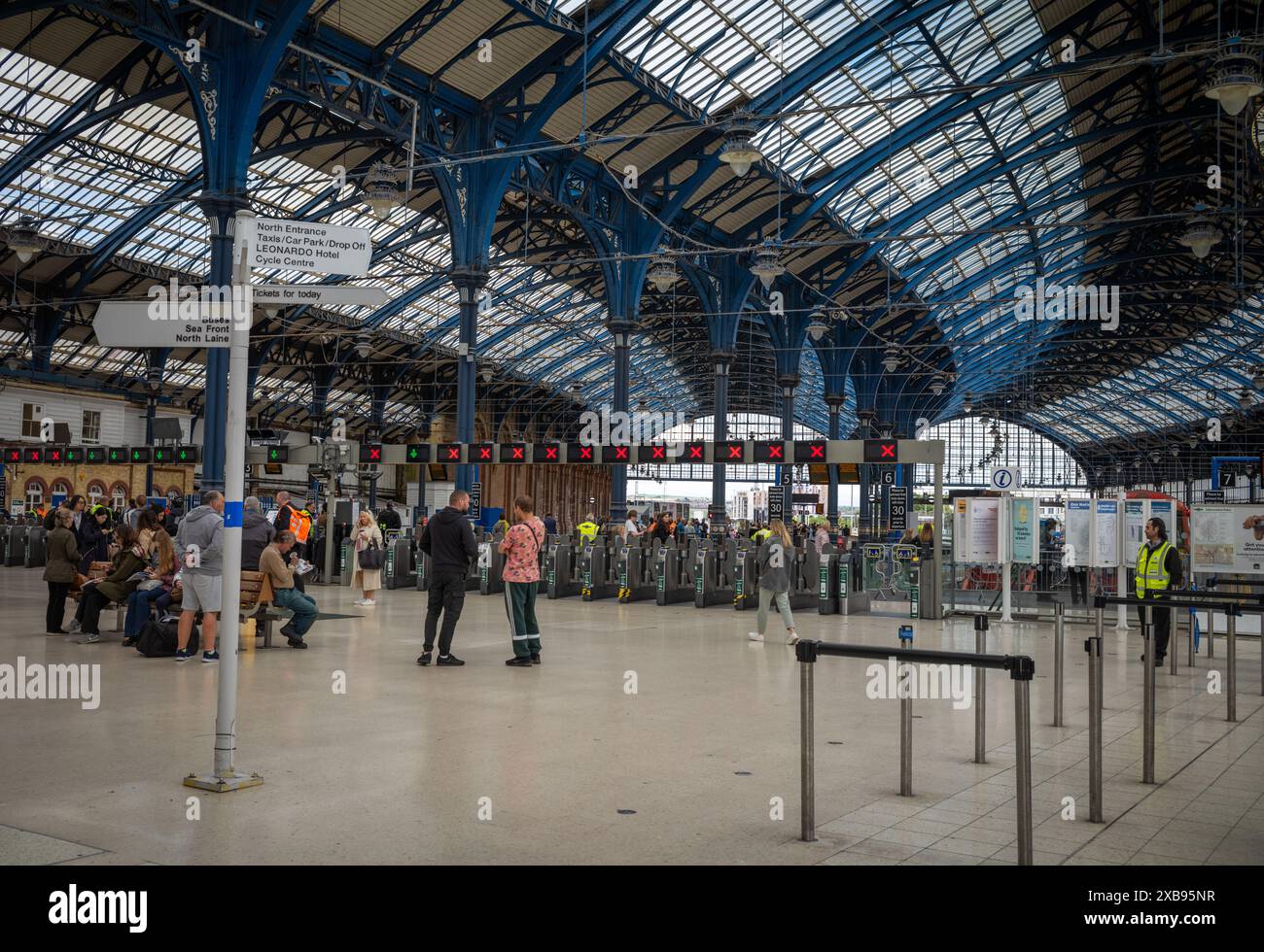 A view across the main concourse towards ticket barriers and under the ...