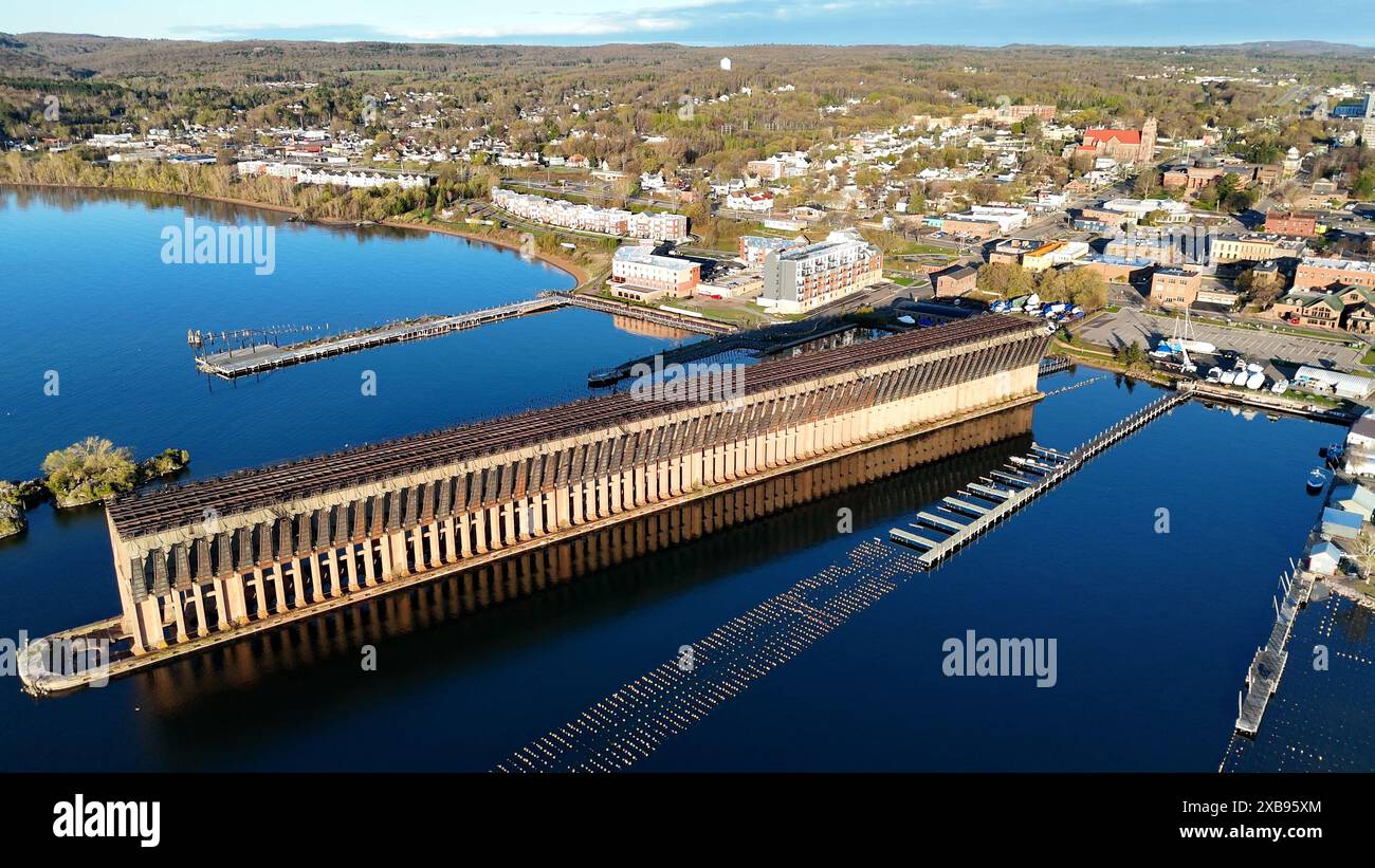 An aerial view of a large dock with arch structures with a cityscape ...