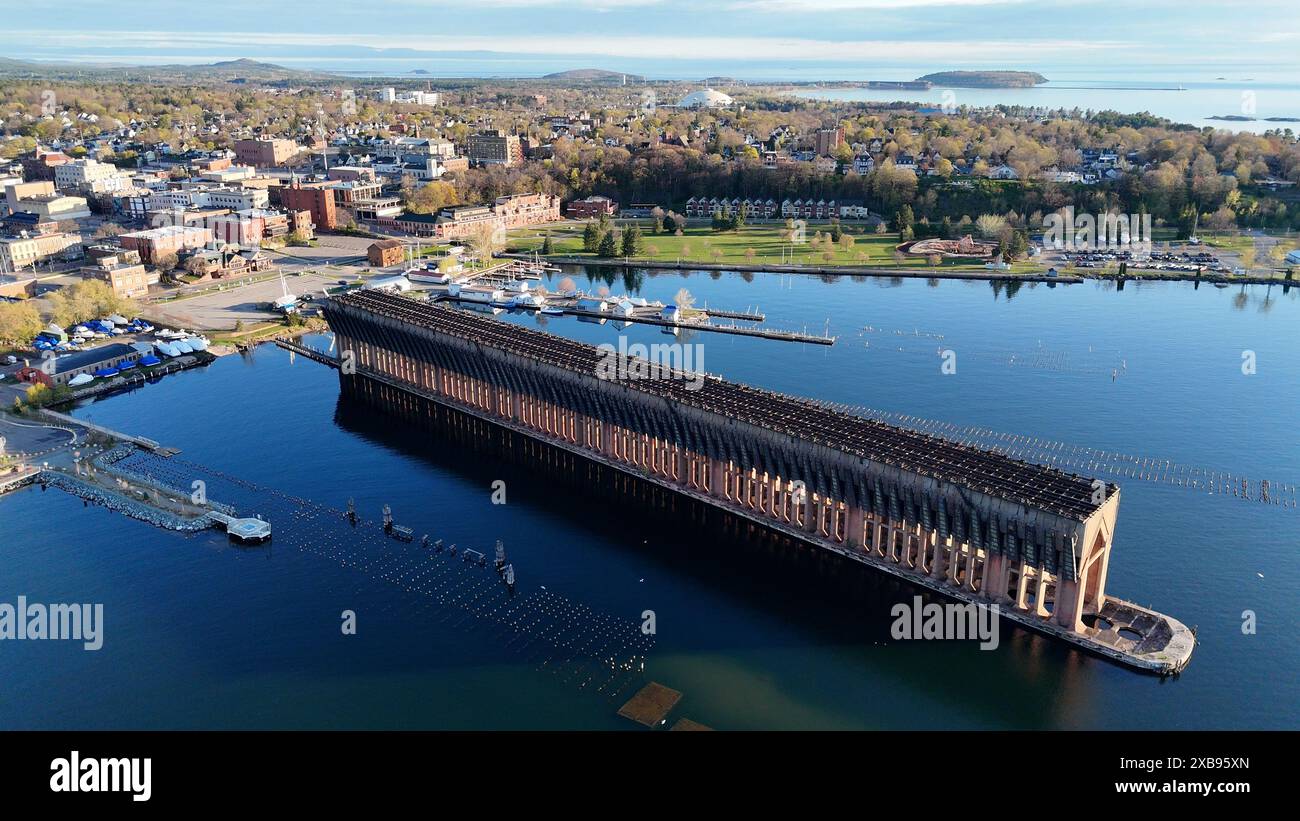 An aerial view large dock with arch structures with a cityscape and ...