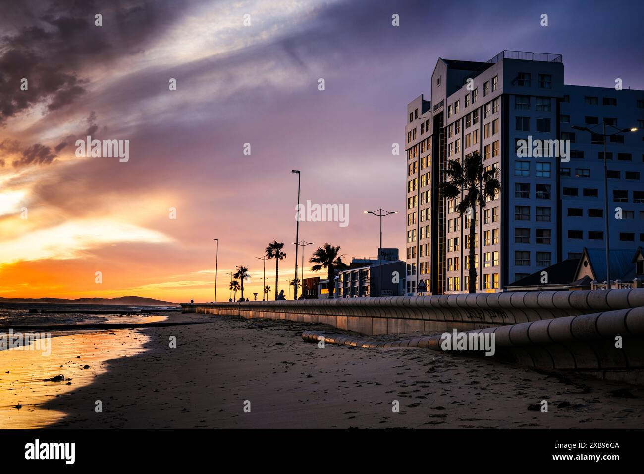 A beautiful sunset along a beach promenade in Strand, Western Cape ...
