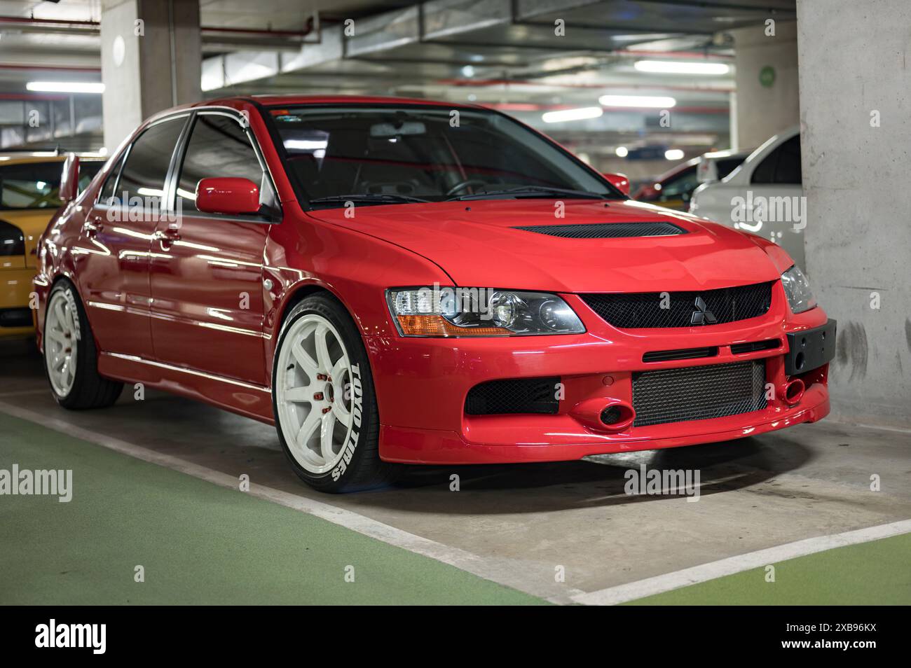 Front view of the red Mitsubishi Lancer Evolution IX parked in the ...