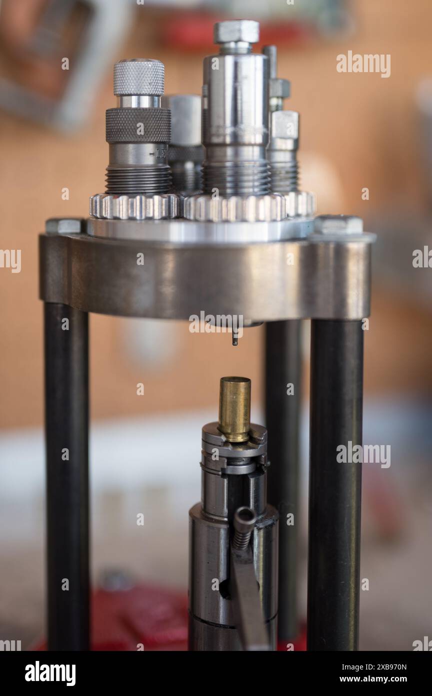 Detail of the decapping and resizing process of a 9mm case in the ...