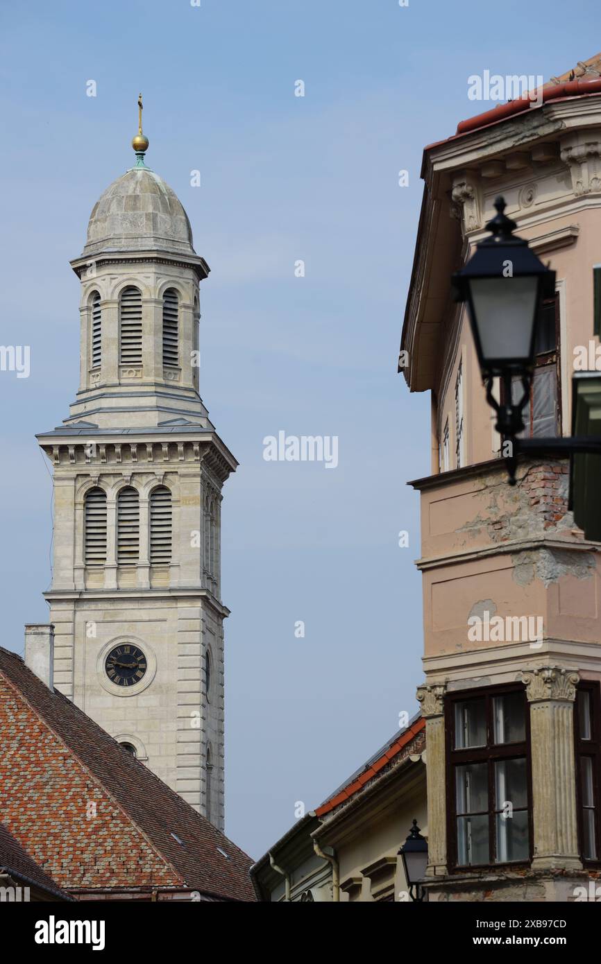 A vintage clock tower amidst old town buildings Stock Photo - Alamy