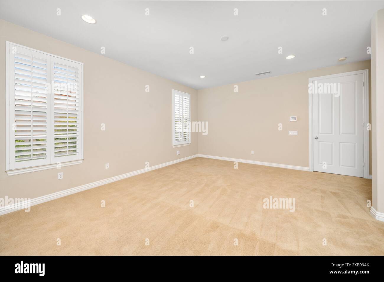 An empty room with tan walls and windows. California, USA Stock Photo ...