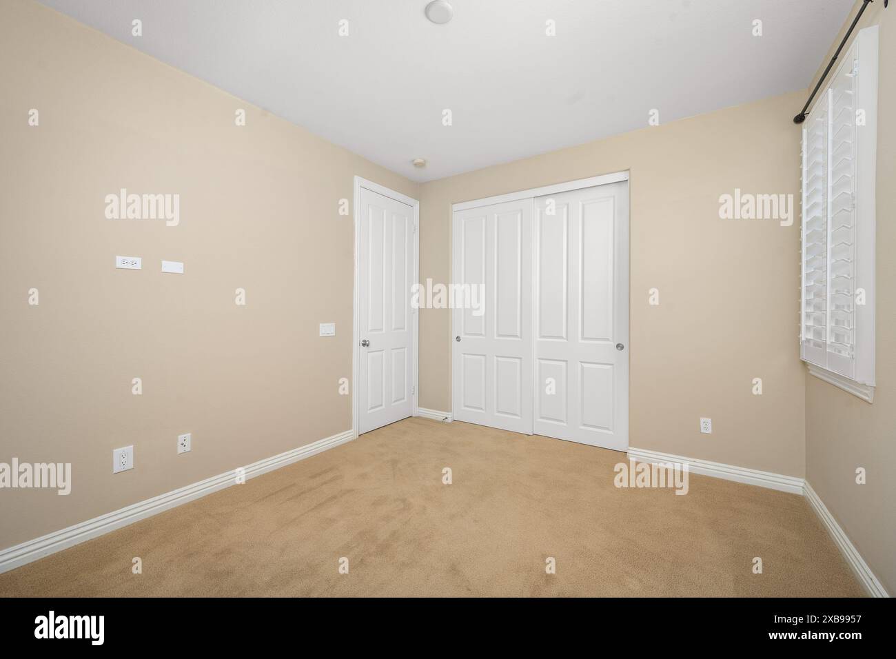 An empty room with tan walls and white doors. California, USA Stock ...
