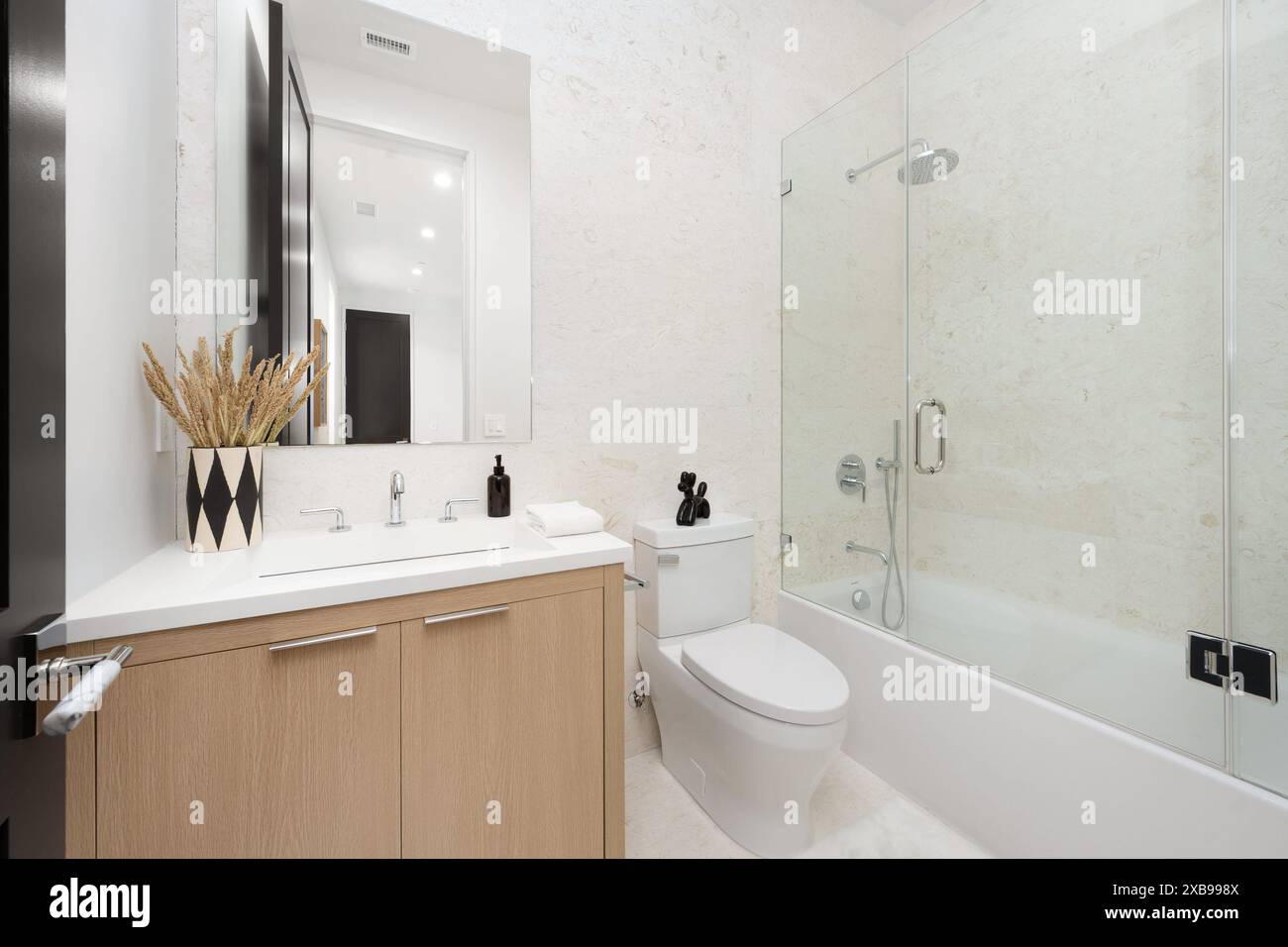 A toilet and shower next to the bathtub in a tidy bathroom Stock Photo - Alamy