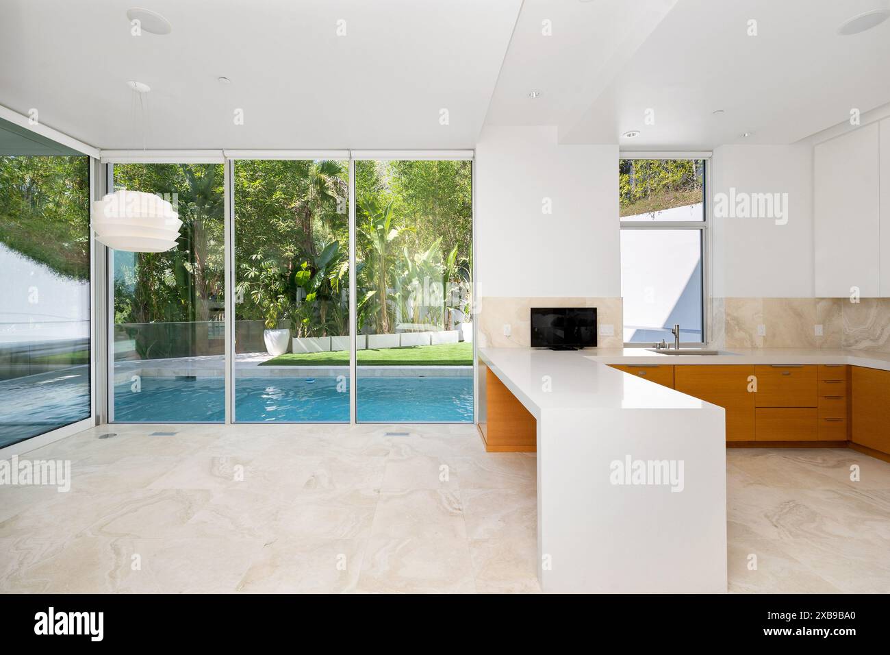A Kitchen with table and refrigerator next to window Stock Photo - Alamy