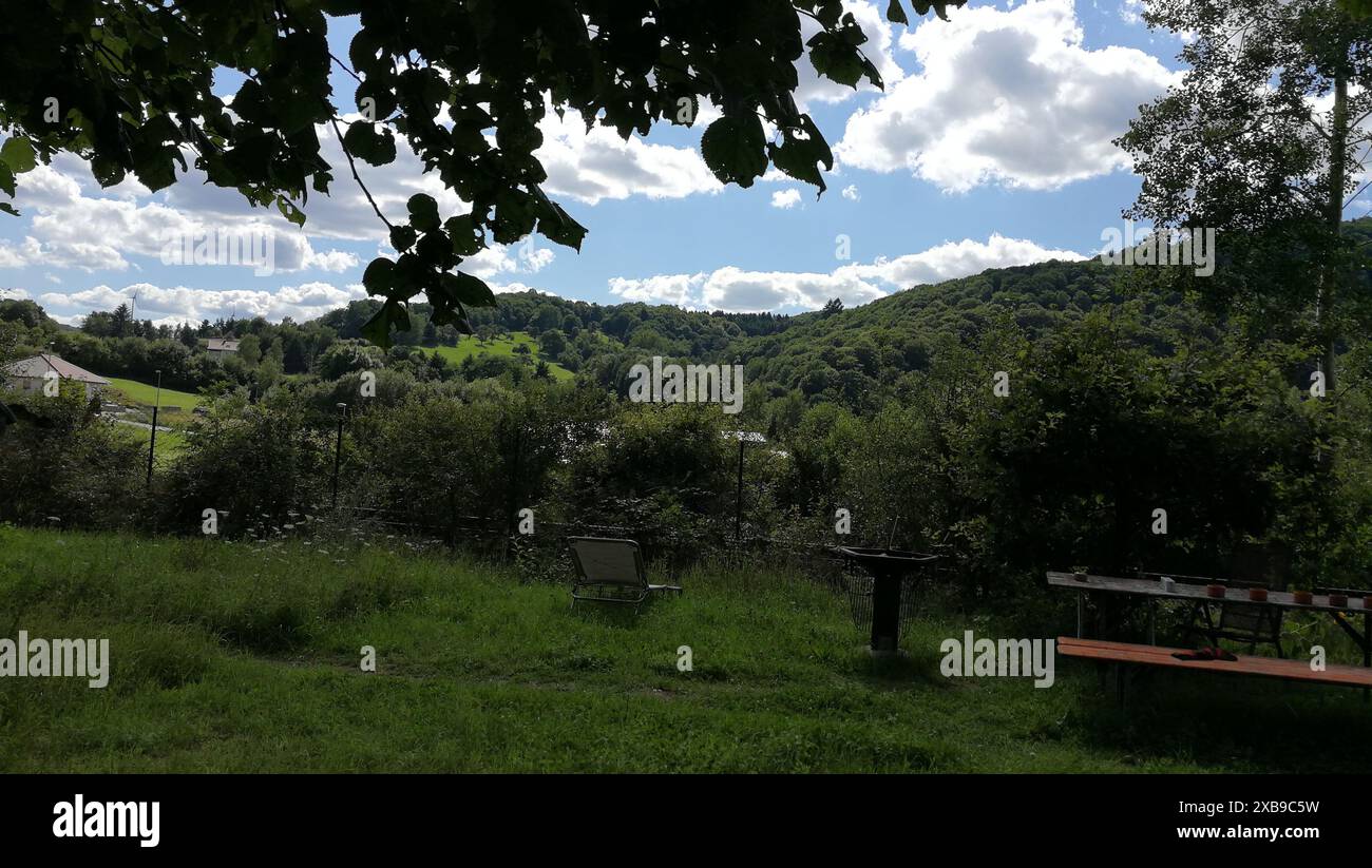 Scenic bench under tree with valley view Stock Photo - Alamy