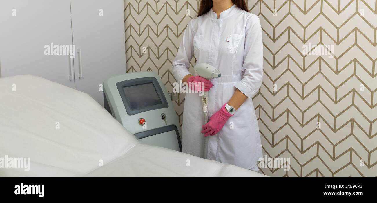 Female dermatologist posing with diode laser hair removal tool. Female ...